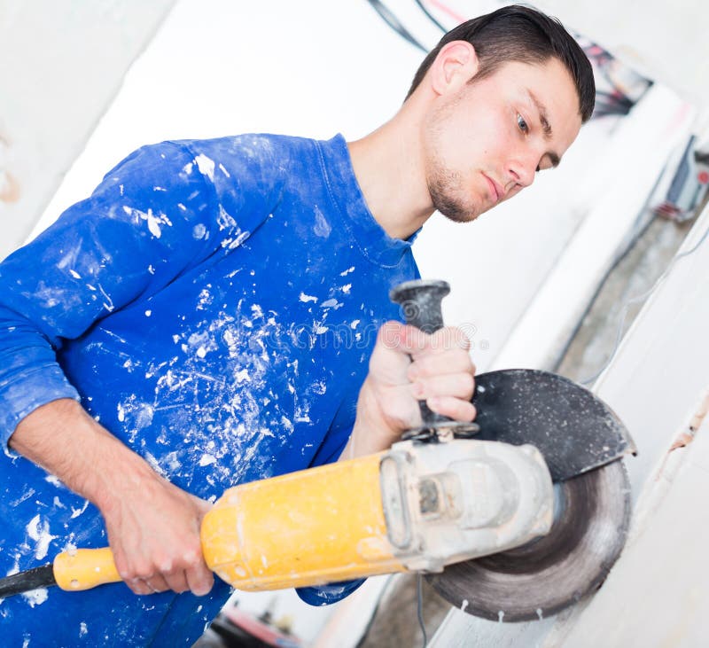 Male Contractor Using Angle Grinder Stock Image - Image of industry ...