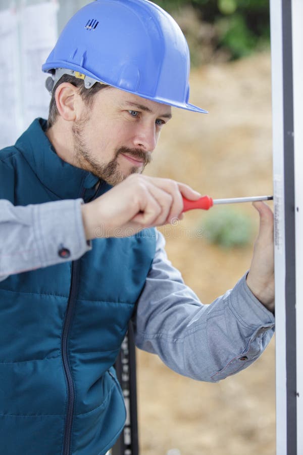 Male Contractor Using Screwdriver while Installing Door Stock Image ...
