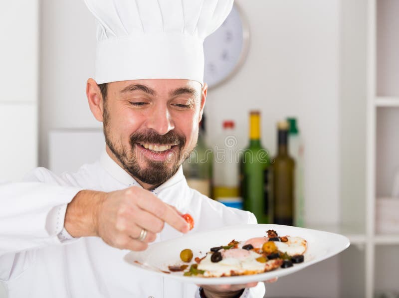 Male cook preparing food stock photo. Image of restaurant - 86112400