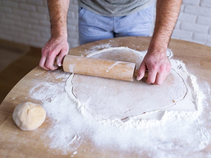 The Male Cook Rolls Dough on a Table. Stock Image - Image of dough ...