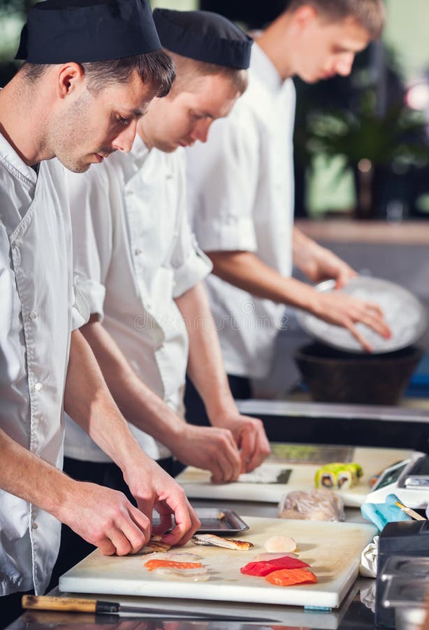 Male cooks preparing sushi stock photo. Image of meat - 62170498