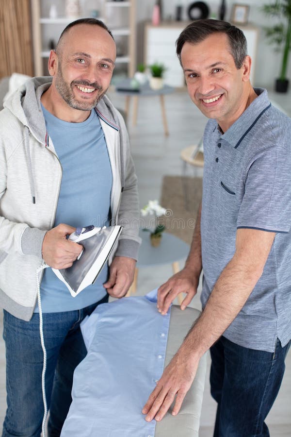 Male Coupe Doing Housework Ironing Stock Image - Image of home, indoors ...