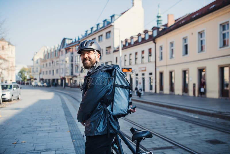 Male Courier with Backpack Delivering Packages in City. Stock Photo ...