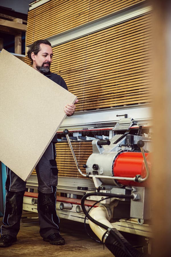Male Craftman is Working with a Vertical Panel Saw Stock Photo - Image ...