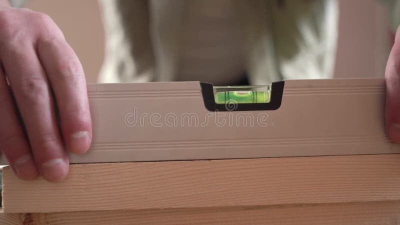 A Male Craftsman Measures the Plane with the Building Level of His ...