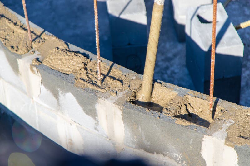 Male Craftsman Pouring Concrete into Concrete Bricks. Selective Focus ...