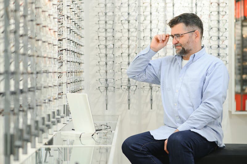 Male Customer Choosing Glasses in Optics Store Stock Photo - Image of ...