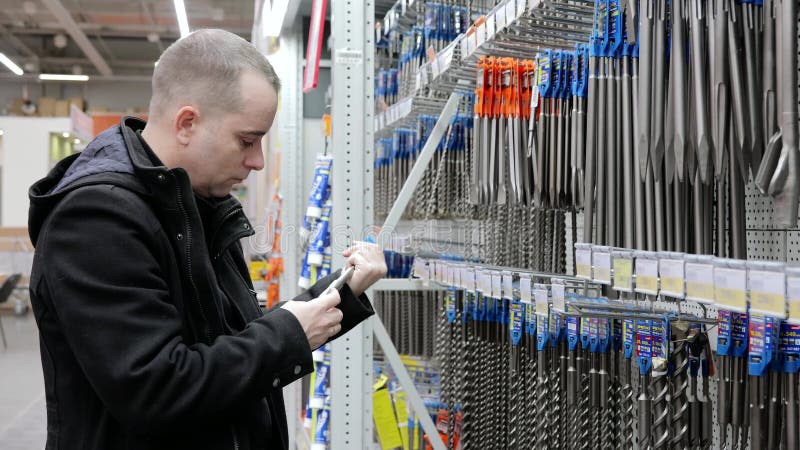 Male Customer Comparing Drill Bits in Hardware Store, Carefully ...