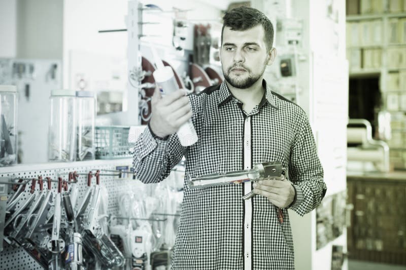 Male Customer Examining Various Glue Tubes in Store Stock Image - Image ...