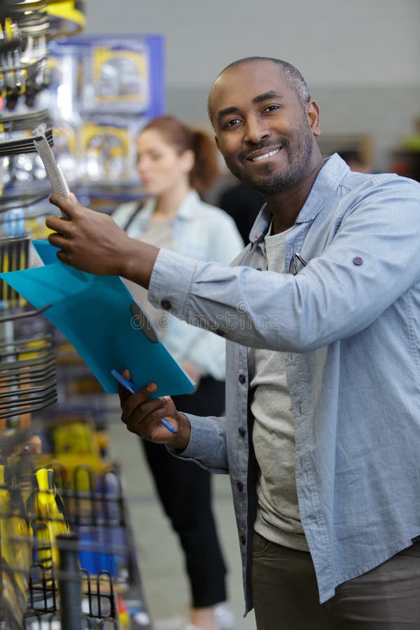 Male Customer in Hardware Store Selecting Products Stock Photo - Image ...