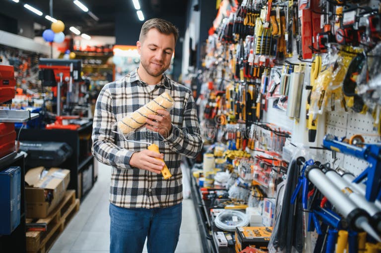 A Male Customer in a Modern Hardware Store Chooses a Paint Roller Stock ...