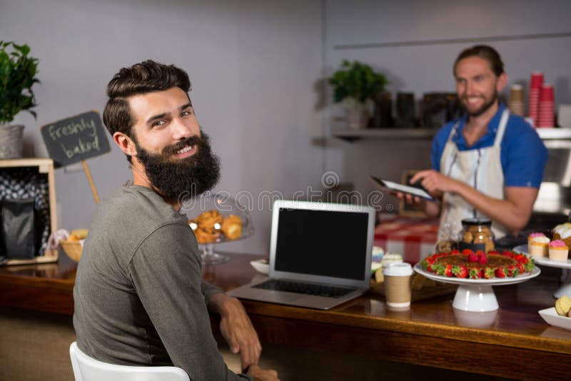 Male Customer Using Laptop while Having Coffee at Counter in Coffee ...