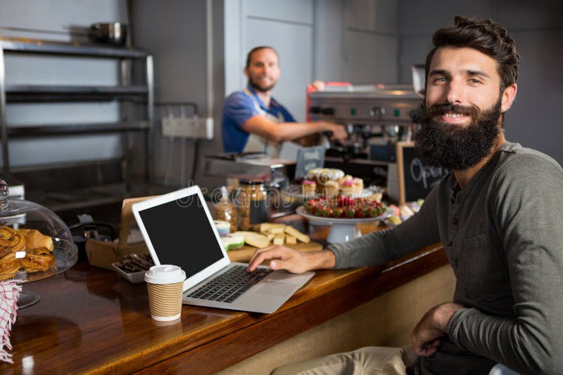 Male Customer Using Laptop while Having Coffee at Counter in Coffee ...