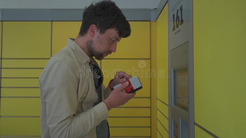 Male Customer Using Self-service Automated Delivery Terminal To Send ...