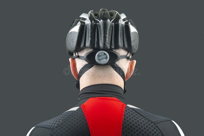Male Cyclist in a Bicycle Helmet from the Back on a Dark Background ...