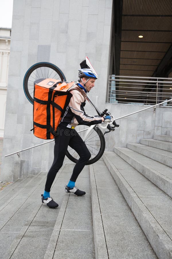 Male Cyclist with Courier Bag and Bicycle Walking Stock Photo - Image ...