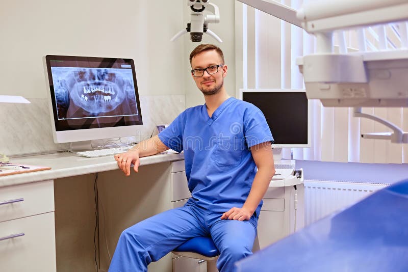 Dentist Looking at Teeth X-ray on the Computer in a Dentist Office ...