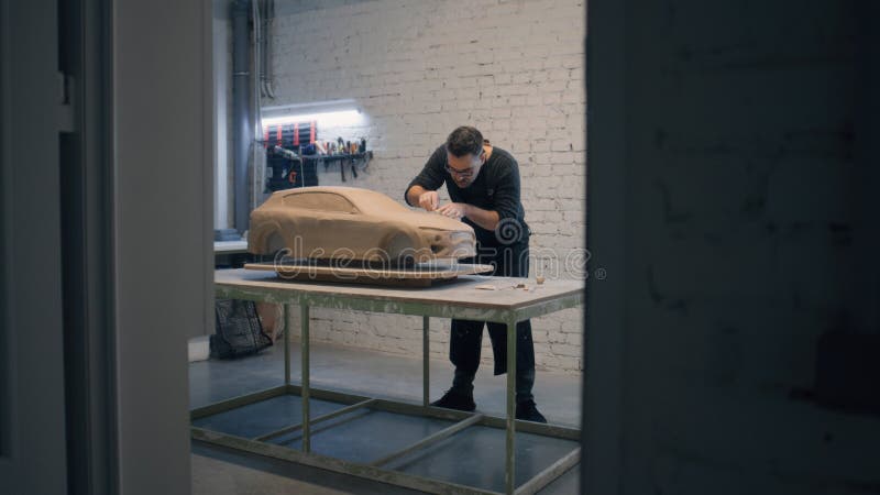 Male Designer Creates Prototype Model of a Car Made of Clay Using ...