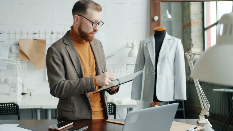 Male Designer Drawing New Garment Sketch Using Modern Tablet Working in ...
