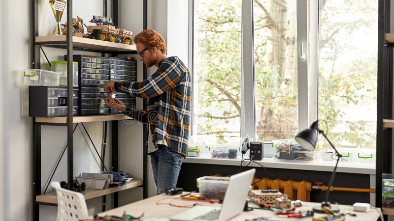 Male it Developer Take Computer Details from Shelf Stock Photo - Image ...