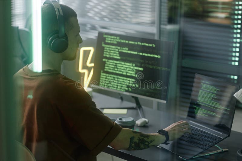 Male it Developer Using Laptop in Headphones Sitting at Office ...