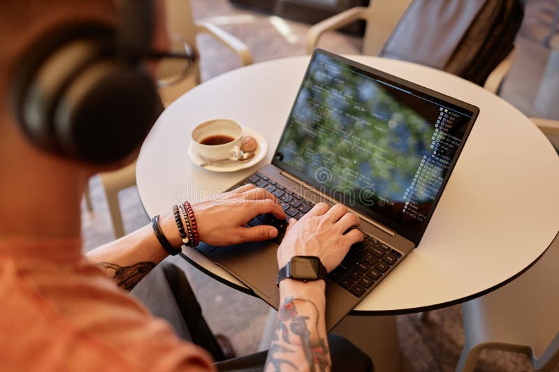 Male it Developer Using Laptop Writing Code while Working at Cafe Table ...
