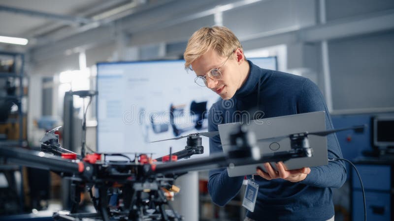 Male Developer Works on Engineering Project, Codes on Laptop and Looks ...