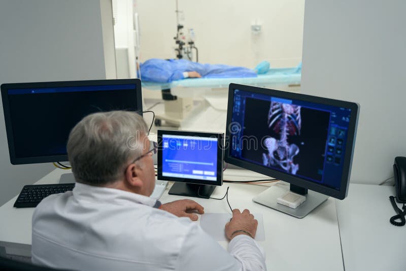 Male Diagnostician Performs a CT Scan Using Modern Equipment Stock ...
