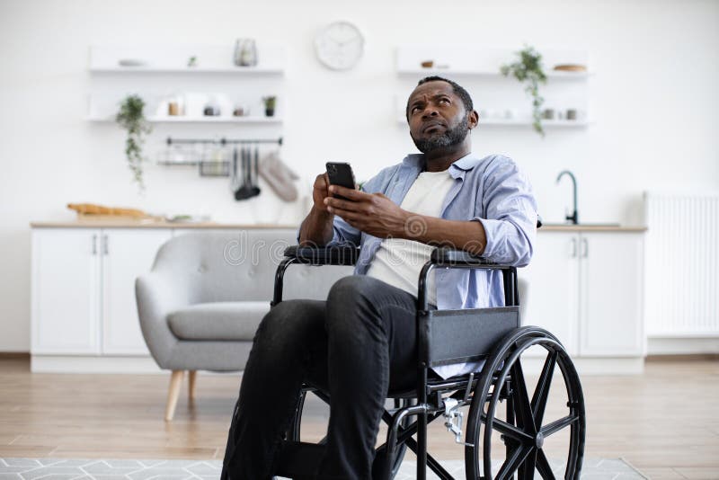 Male with Disability Texting Message on Phone in Dining Room Stock ...