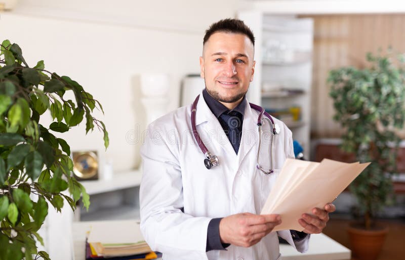 Male Doctor Analyzing Documents in Office Stock Photo - Image of ...
