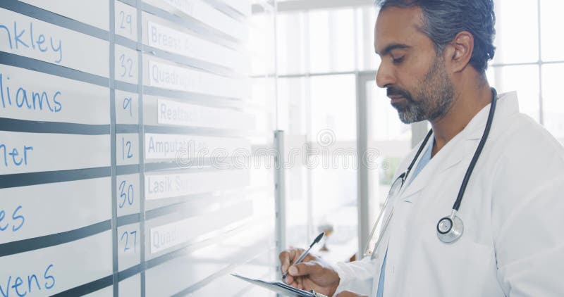 Male Doctor Checking Information Board 4k Stock Video - Video of ...