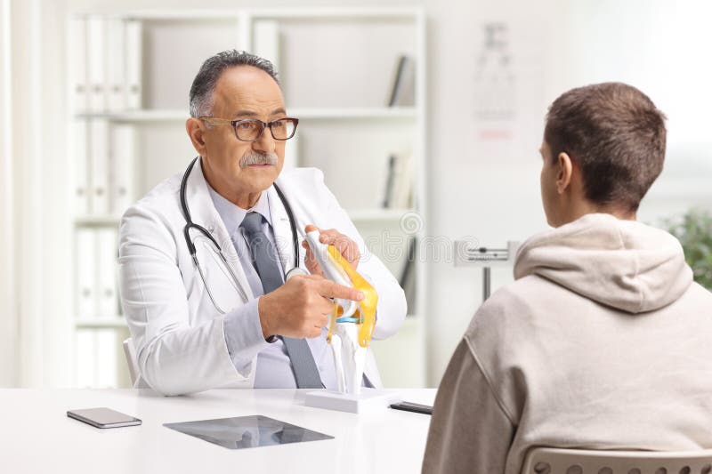 Male Doctor Explaining a Knee Joint To a Male Patient Stock Image ...