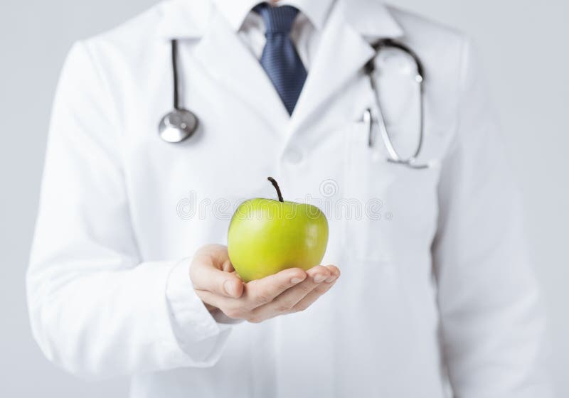 Male Doctor with Green Apple Stock Photo - Image of hand, holding: 41964796