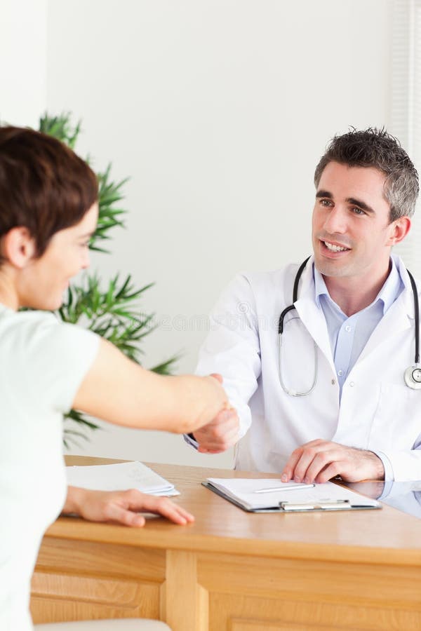 Male Doctor Greeting a Patient Stock Photo - Image of lifestyle, hand ...