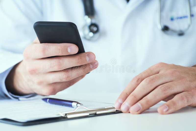 Male Doctor Hands with Mobile Phone Close-up. Male Doctor in White Coat ...