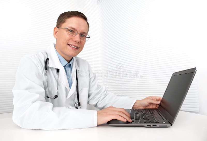 Male doctor with laptop stock photo. Image of care, table - 28214312