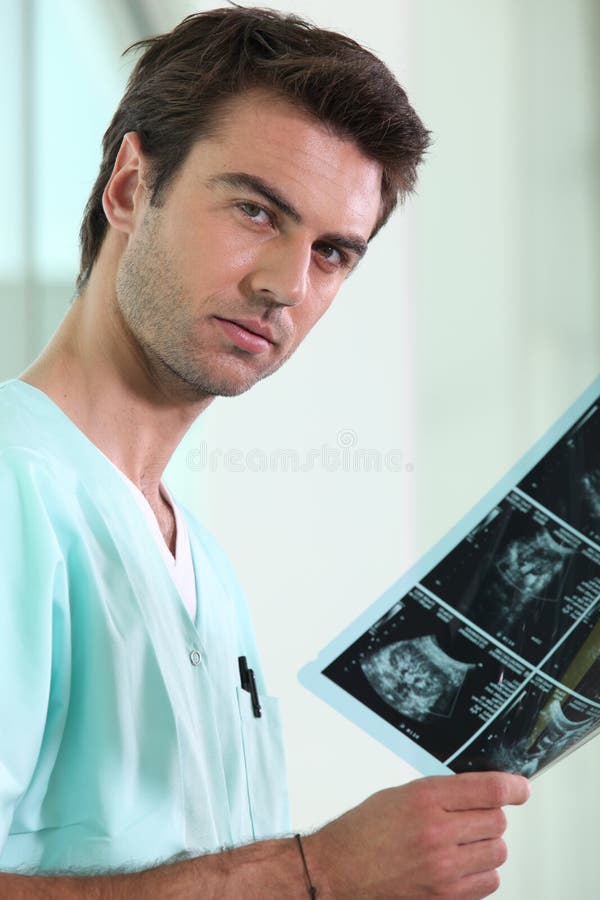 Male Doctor with X-ray Image Stock Photo - Image of scrubs, healthcare ...