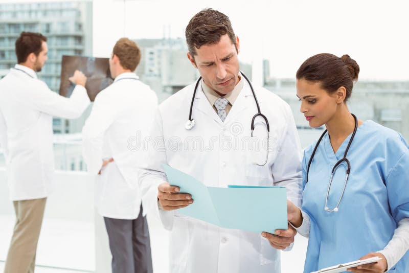 409 Doctor Looking Reports Stock Photos - Free & Royalty-Free Stock ...