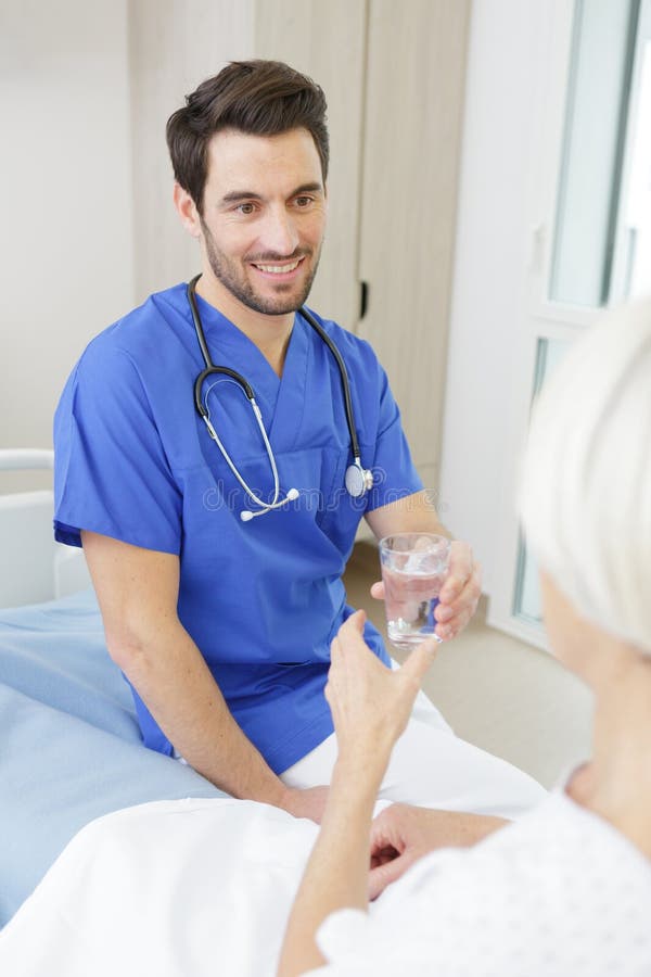 Male Doctor Taking Care Retired Patient Stock Photo - Image of together ...