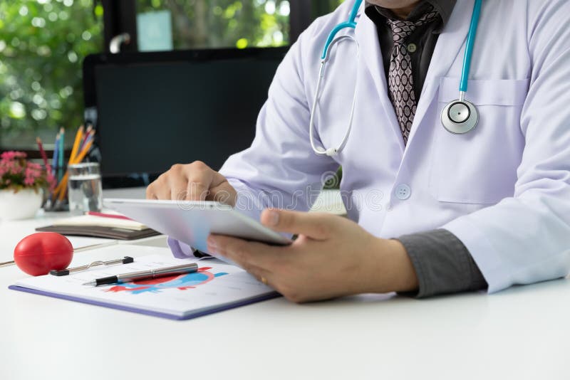 Male Doctor Using Computer Tablet in Medical Office at Hospital Stock ...