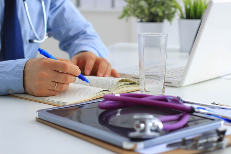Male Doctor Using a Laptop, Sitting at His Desk Stock Image - Image of ...