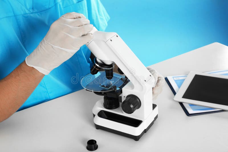 Male Doctor Using Microscope at Table. Medical Object Stock Image ...