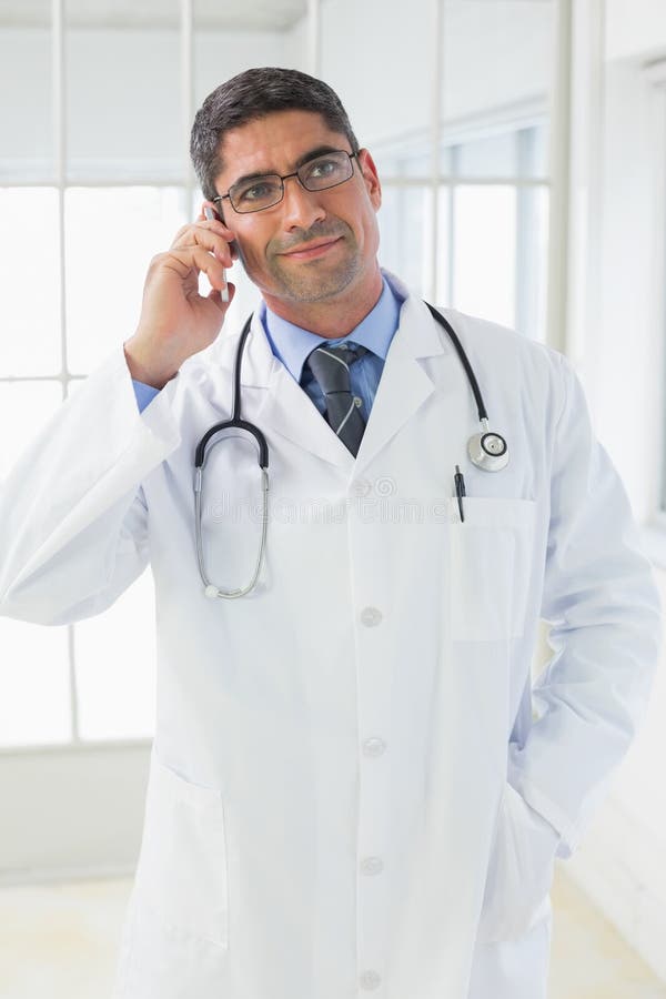 Male Doctor Using Mobile Phone in Hospital Stock Photo - Image of ...