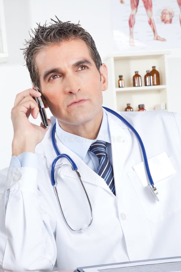 Male Doctor Using Mobile Phone Stock Photo - Image of medicine, mobile ...