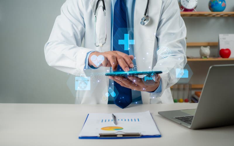 Male Doctor Using Tablet To Review Treatment Plan and Write Document ... Male Doctor Using Tablet To Review Treatment Plan and Write Document ...