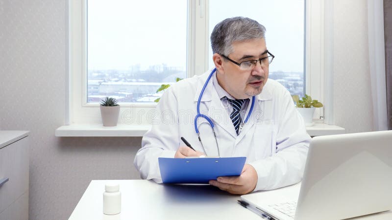 Male Doctor Working on Computer in Office Stock Photo - Image of office ...