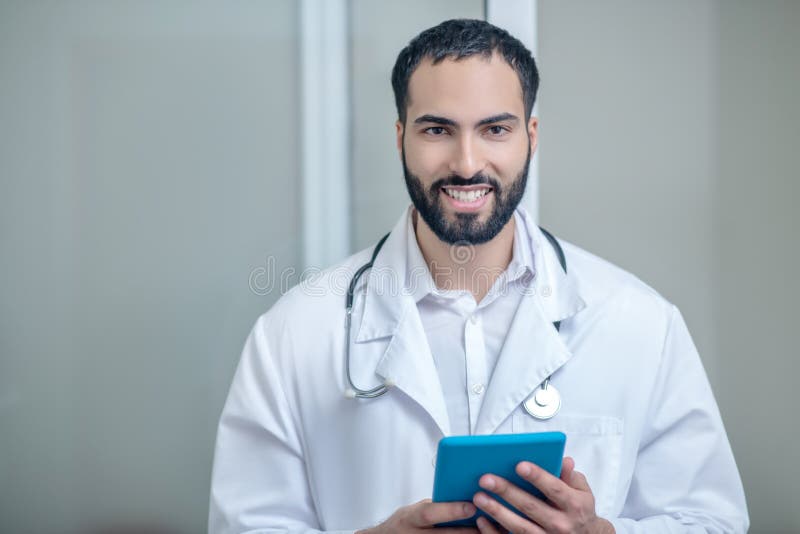 Male Doctor in a White Robe Smiling and Feeling Good Stock Photo ...
