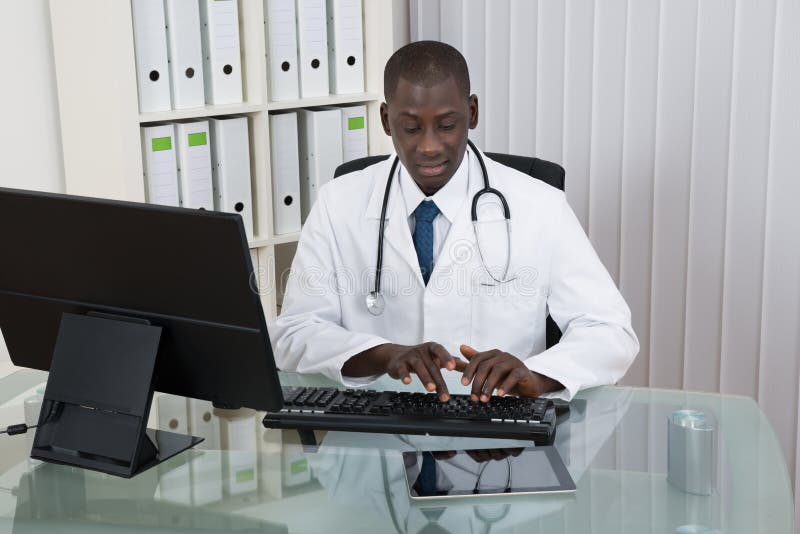 Male Doctor Working on Computer Stock Image - Image of indoor, cheerful ...