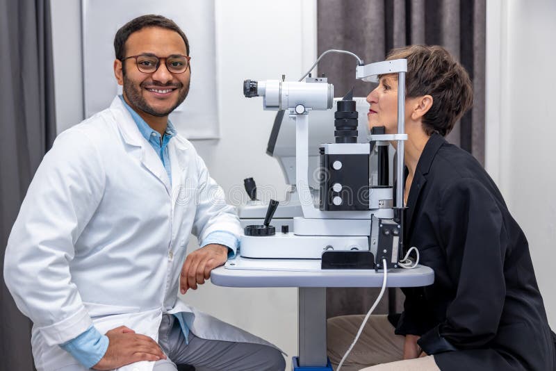 Male Doctor Working on Optometric Equipment at Clinic Stock Photo ...