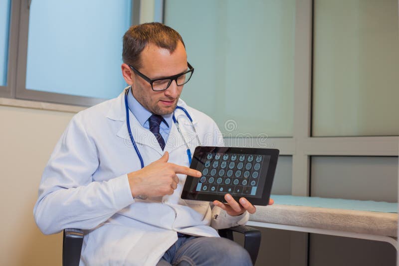 Male Doctor Working with a Tablet Computer in His Office. Hospital ...